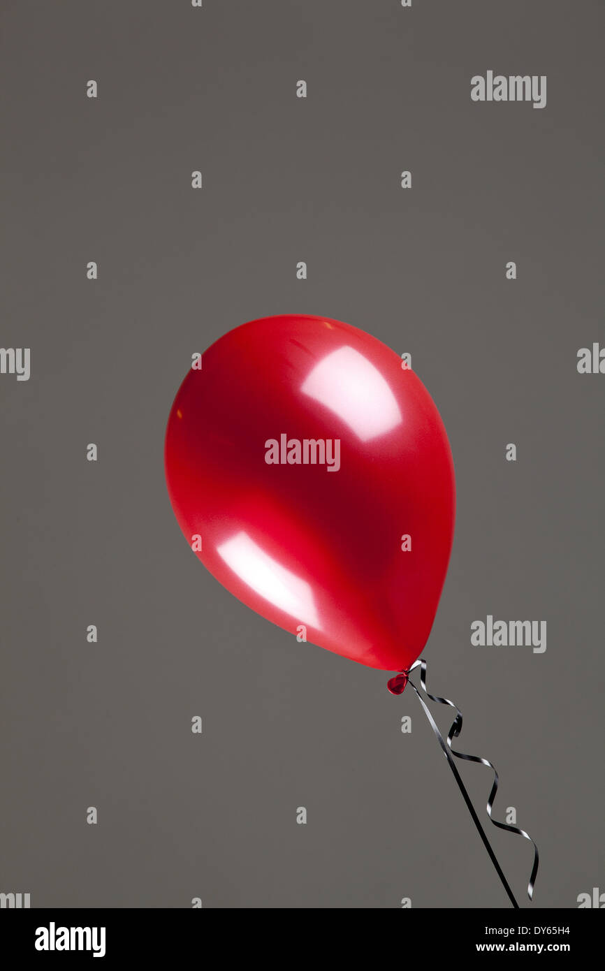 Shiny Red Balloons on a grey background Stock Photo - Alamy