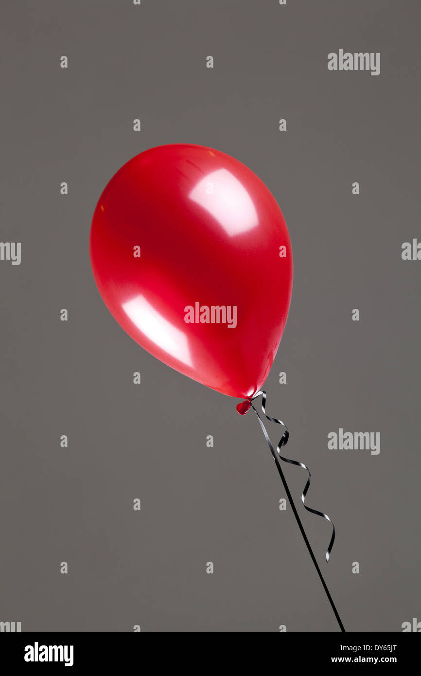 Shiny Red Balloons on a grey background Stock Photo - Alamy