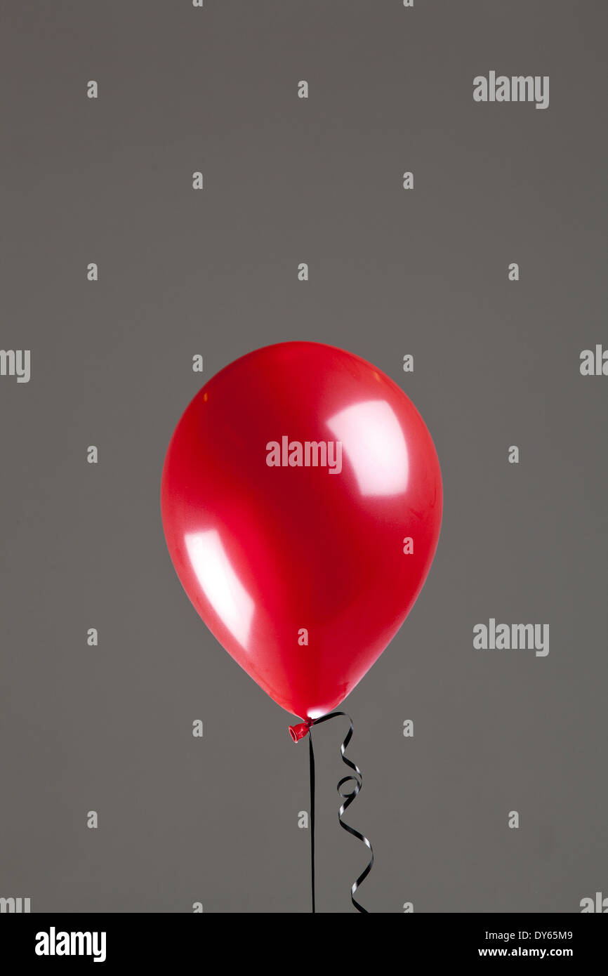 Shiny Red Balloons on a grey background Stock Photo - Alamy
