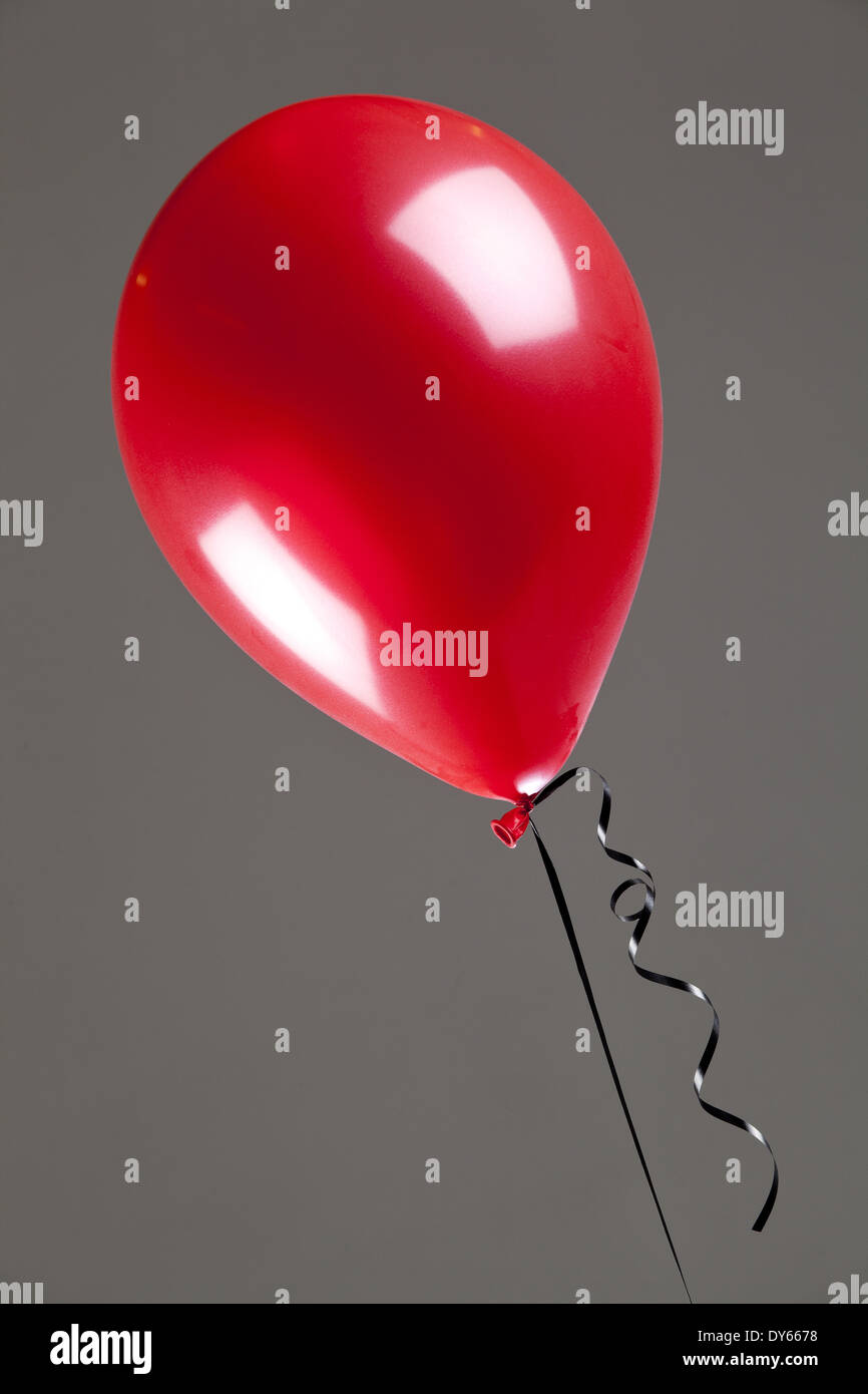 Shiny Red Balloons on a grey background Stock Photo - Alamy