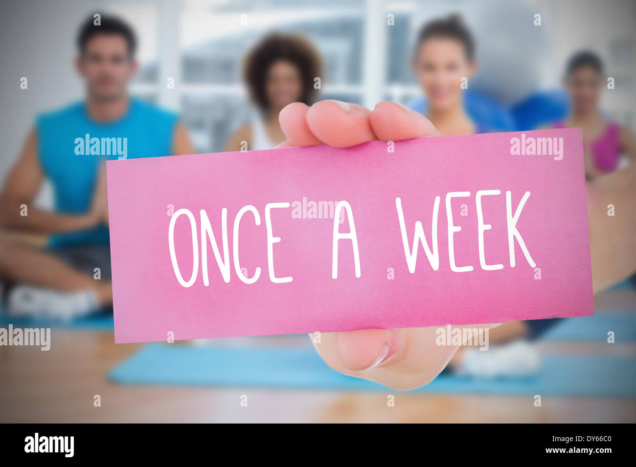Woman holding pink card saying once a week Stock Photo - Alamy