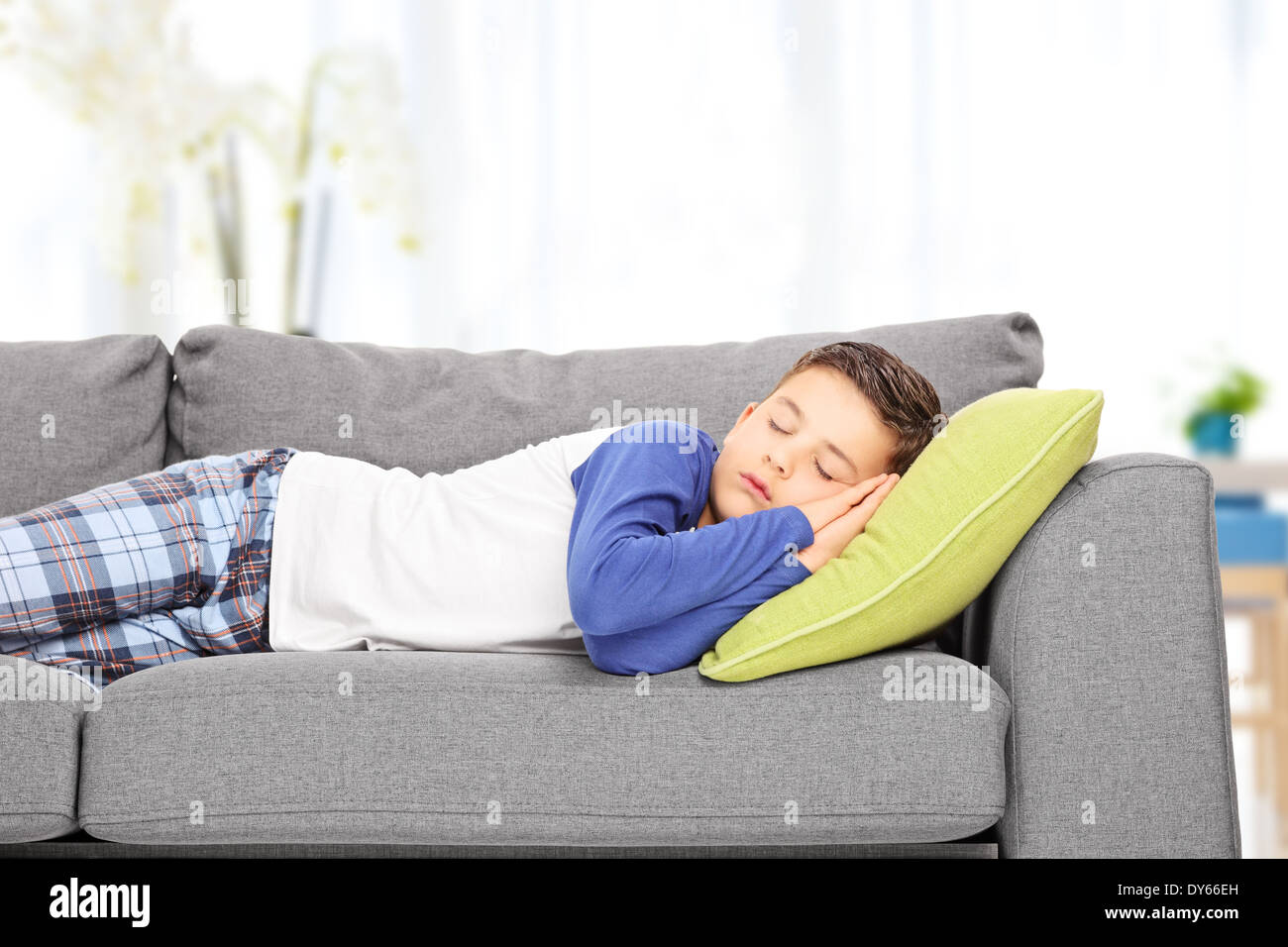 Cute little boy sleeping on sofa at home Stock Photo - Alamy