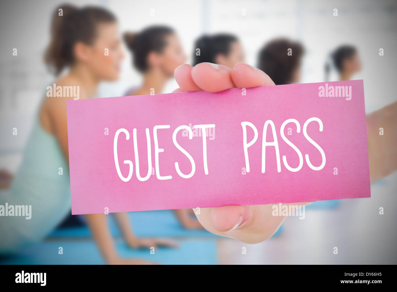 Woman holding pink card saying guest pass Stock Photo - Alamy