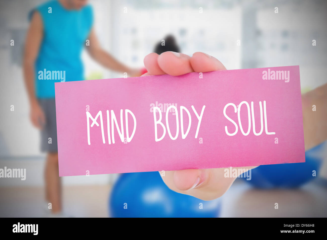 Woman holding pink card saying mind body soul Stock Photo - Alamy