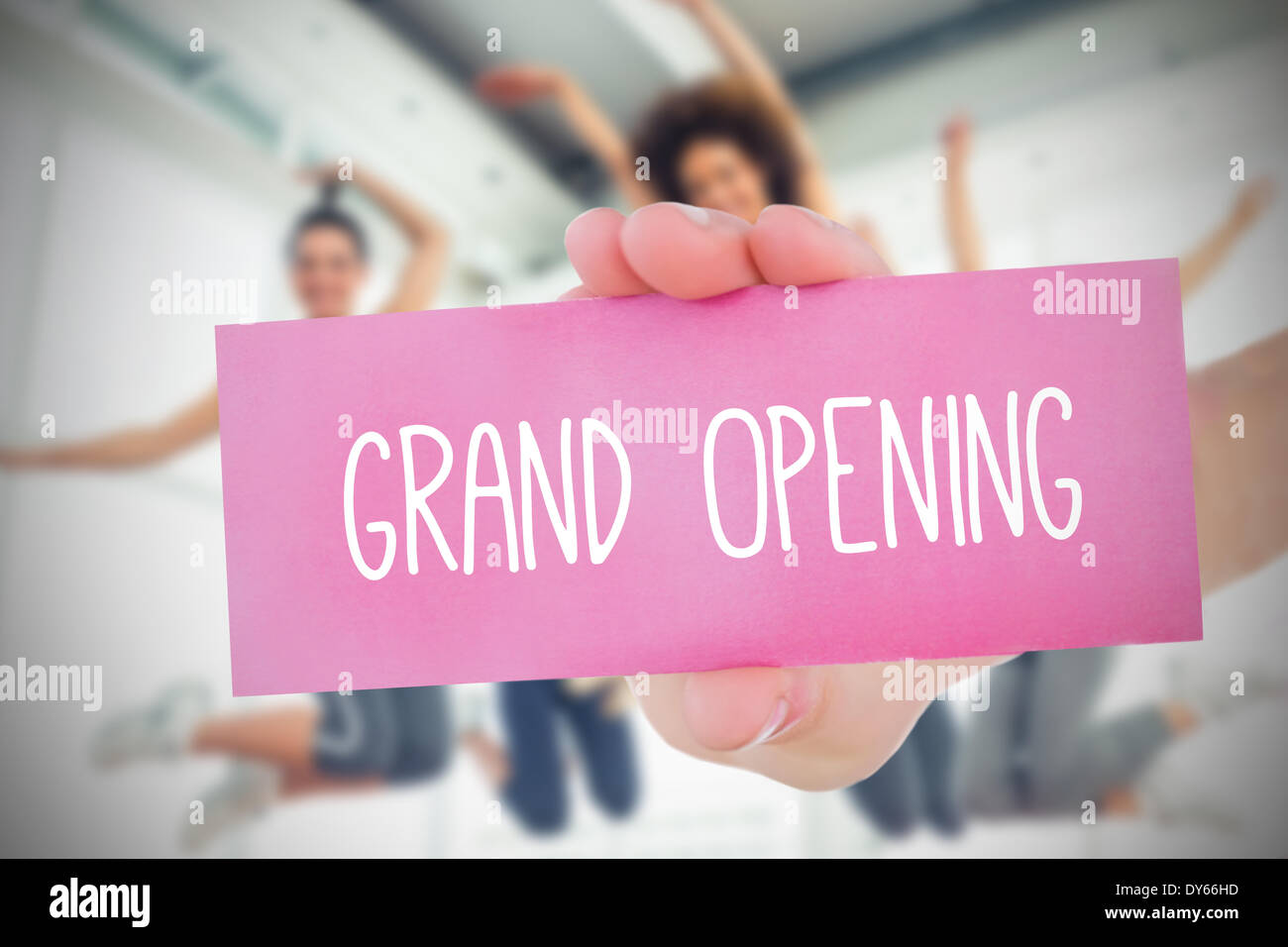 Woman holding pink card saying grand opening Stock Photo - Alamy
