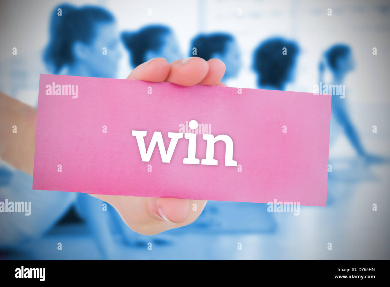 Woman holding pink card saying win Stock Photo - Alamy