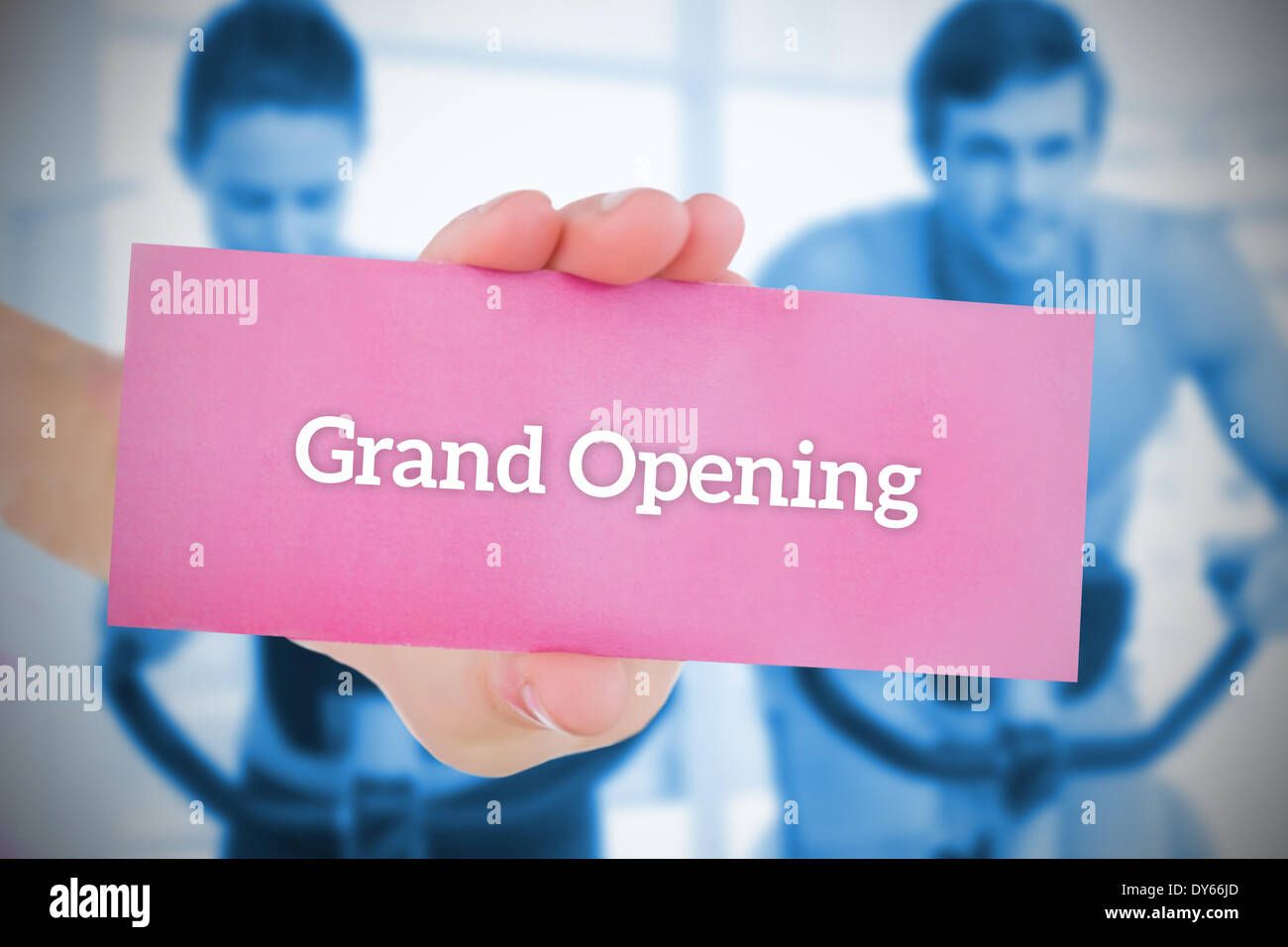Woman holding pink card saying grand opening Stock Photo - Alamy