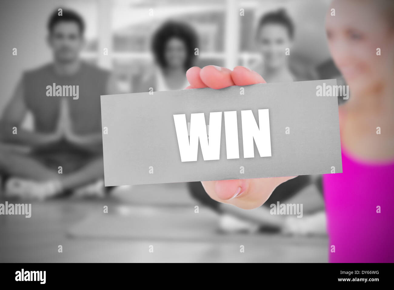 Fit blonde holding card saying win Stock Photo - Alamy