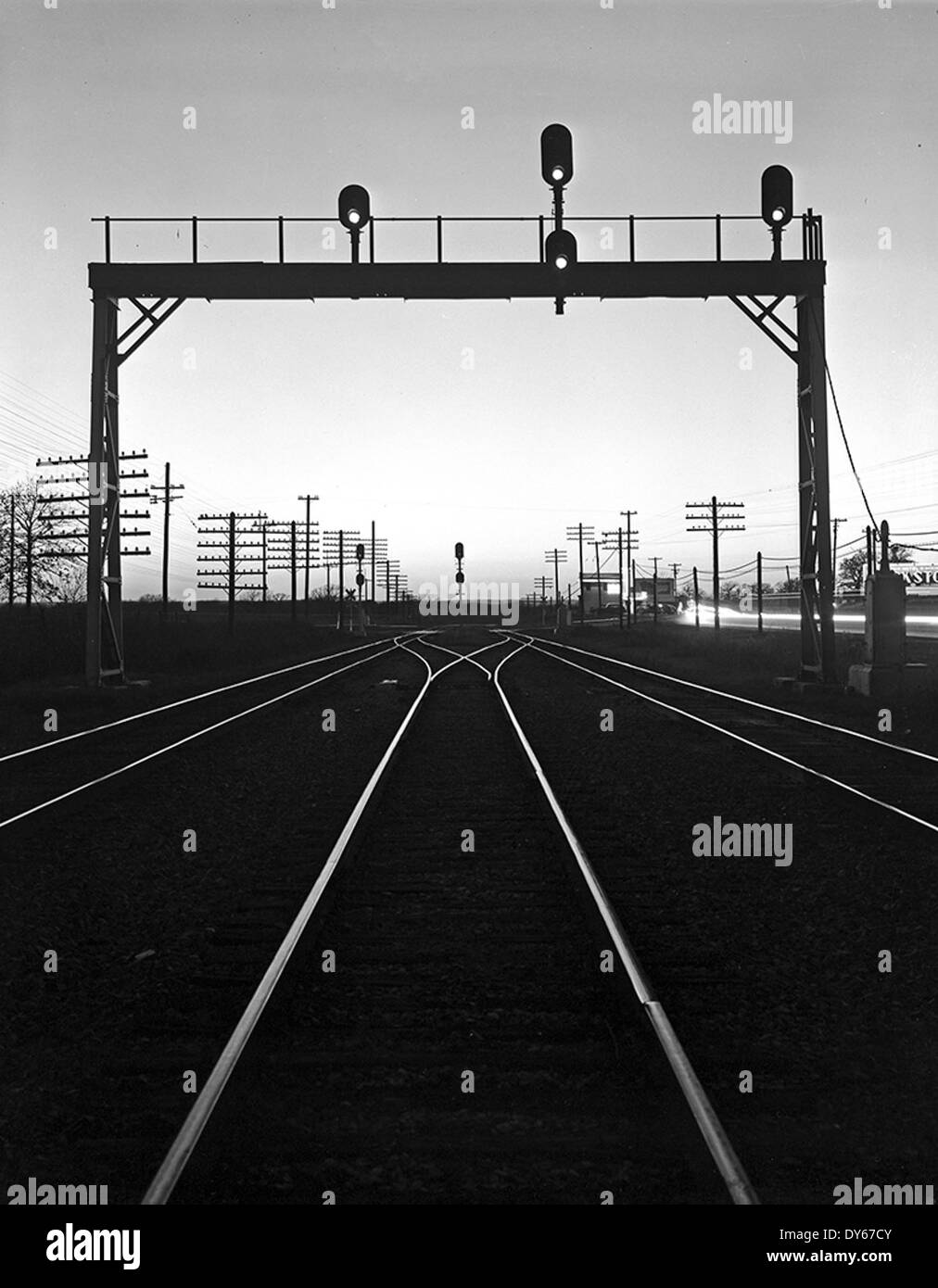 A night-time view of a railway signal bridge at a crossing on the Texas ...