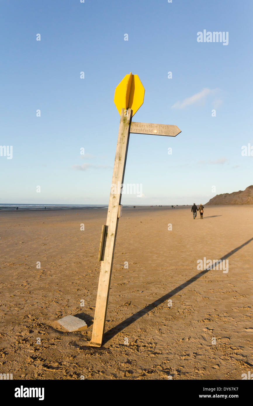 Wooden signpost on the beach at Formby Point, Merseyside, A distant ...