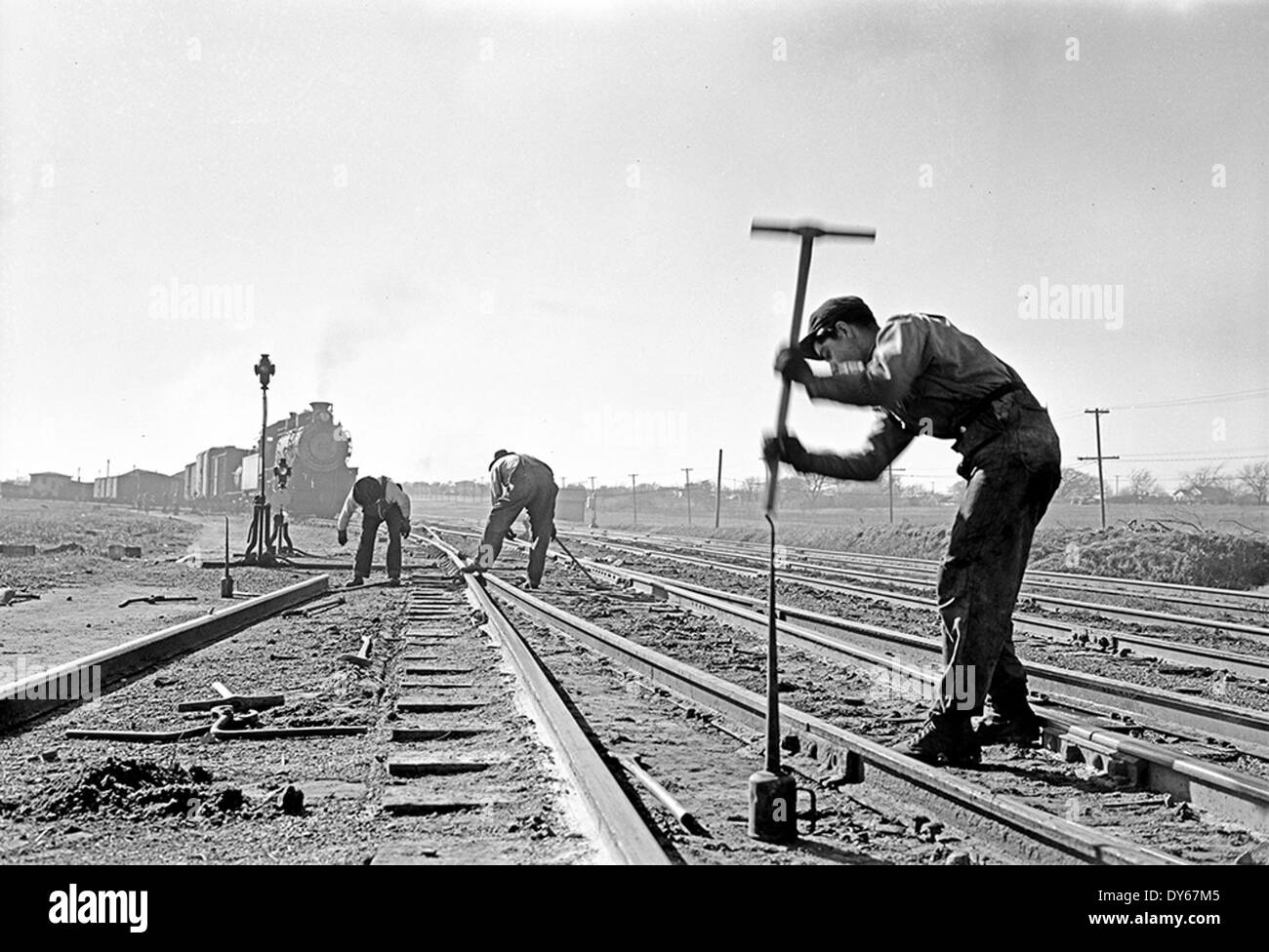 A section maintenance crew works on Locomotive 494, part of the Texas ...