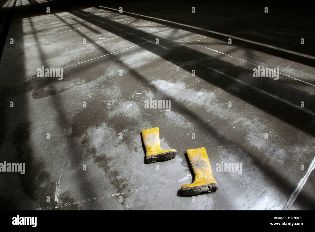 Yellow wellington boots in a building site Stock Photo - Alamy