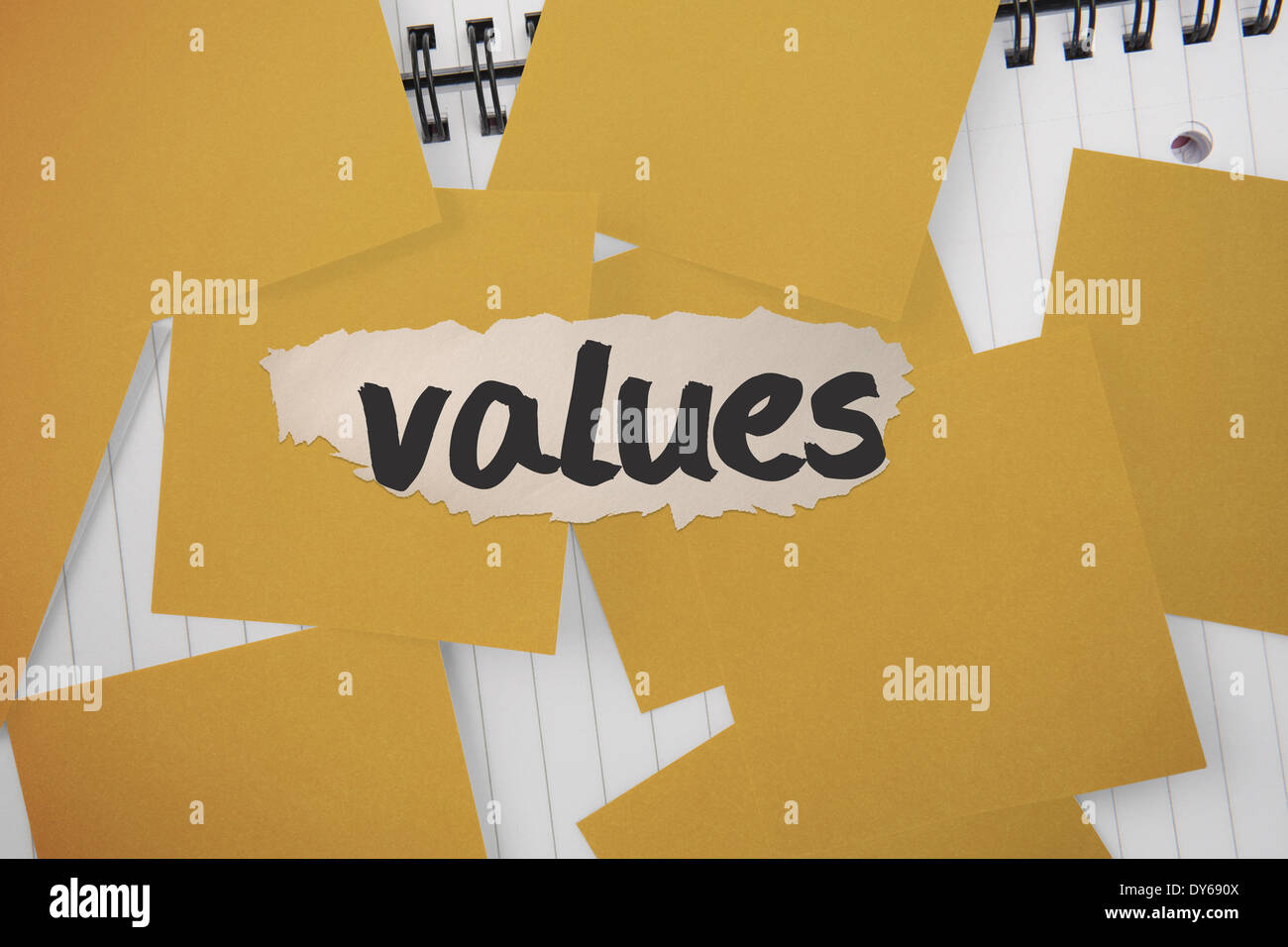 Values against yellow paper strewn over notepad Stock Photo - Alamy