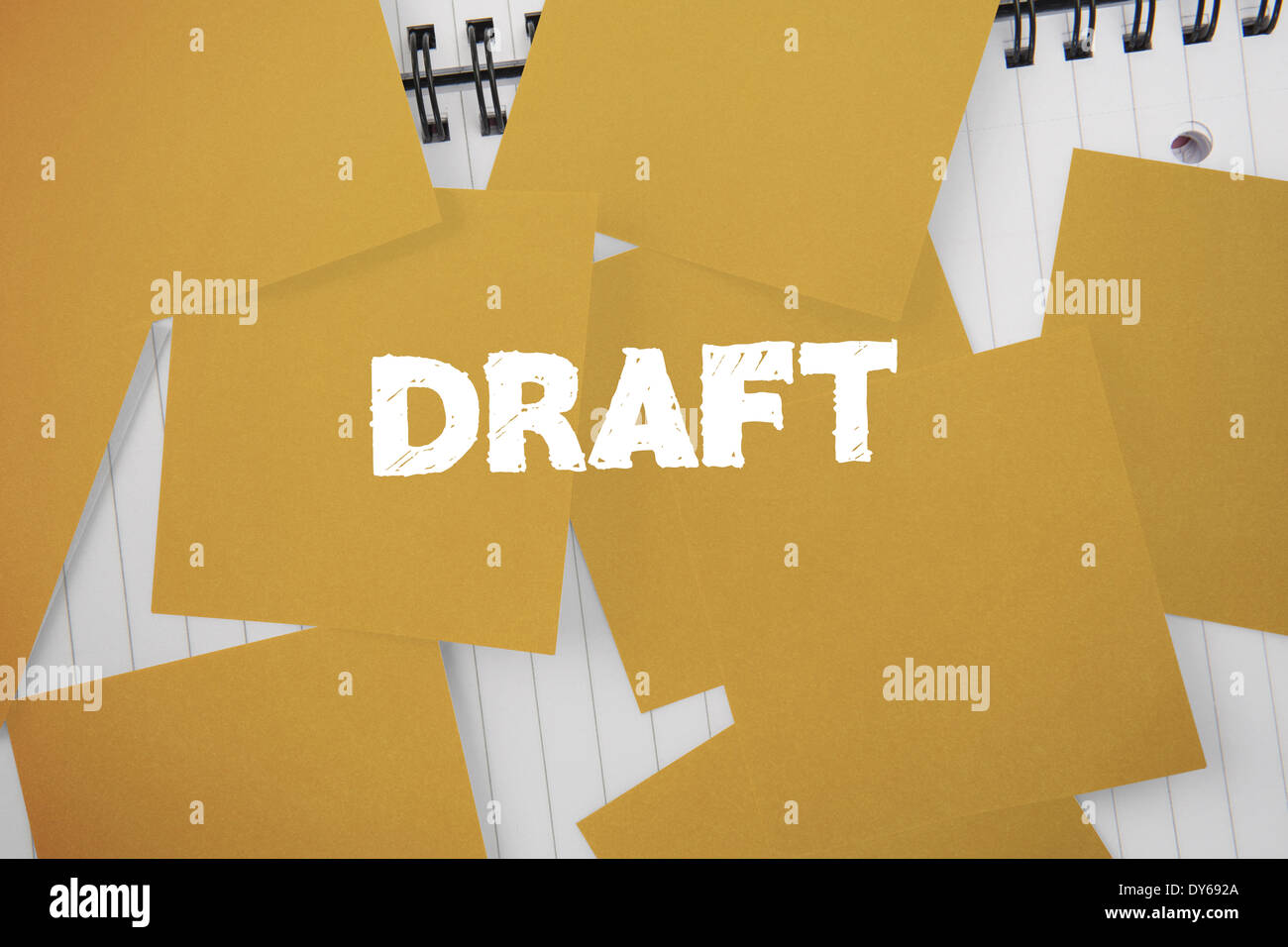 Draft against yellow paper strewn over notepad Stock Photo - Alamy