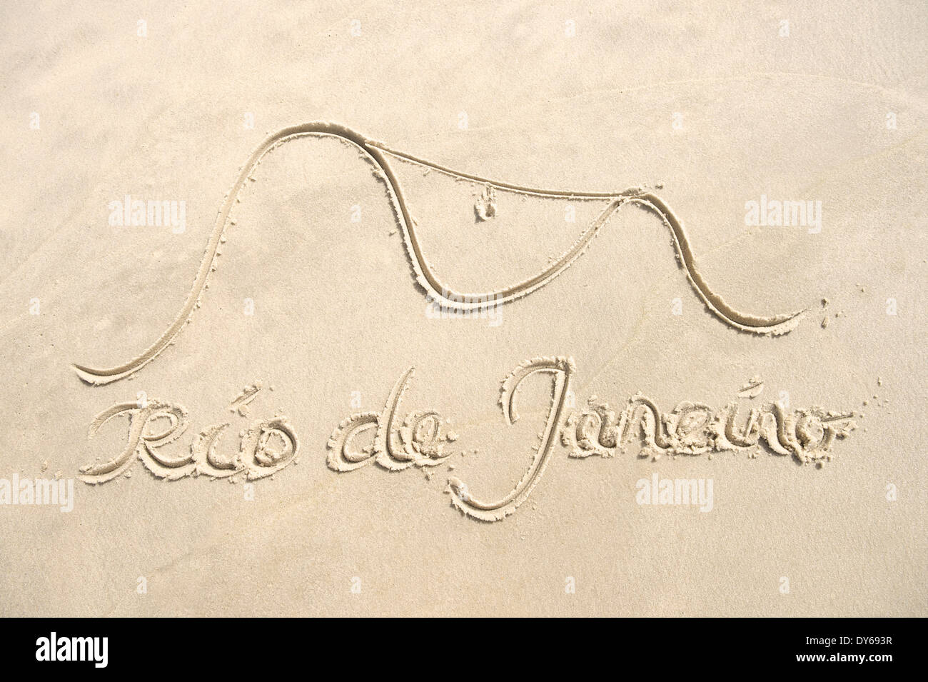 Rio de Janeiro message on sand beach with iconic shape of Sugarloaf ...