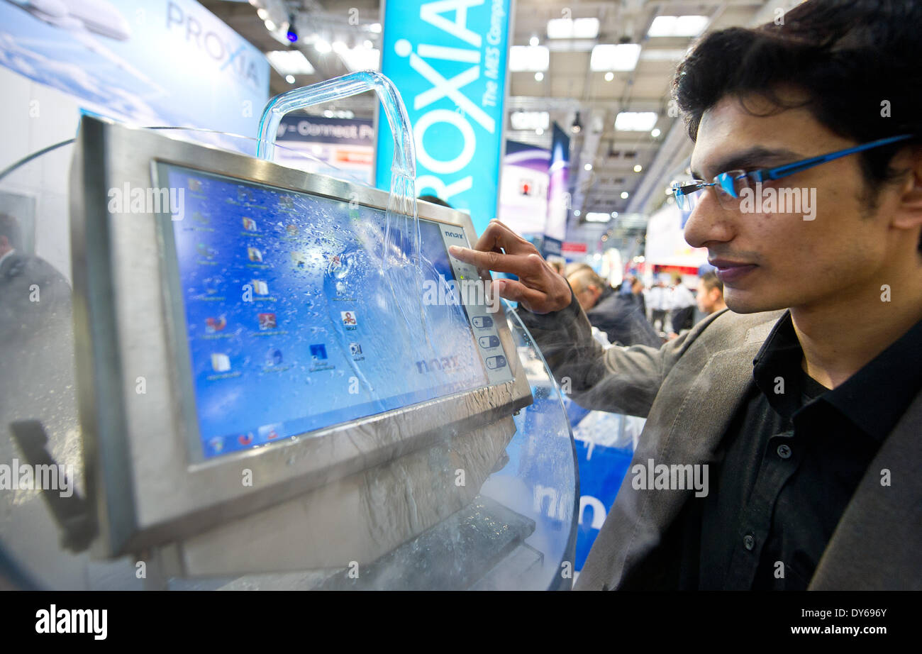 Hanover, Germany. 07th Apr, 2014. A trade fair visitor views an ...