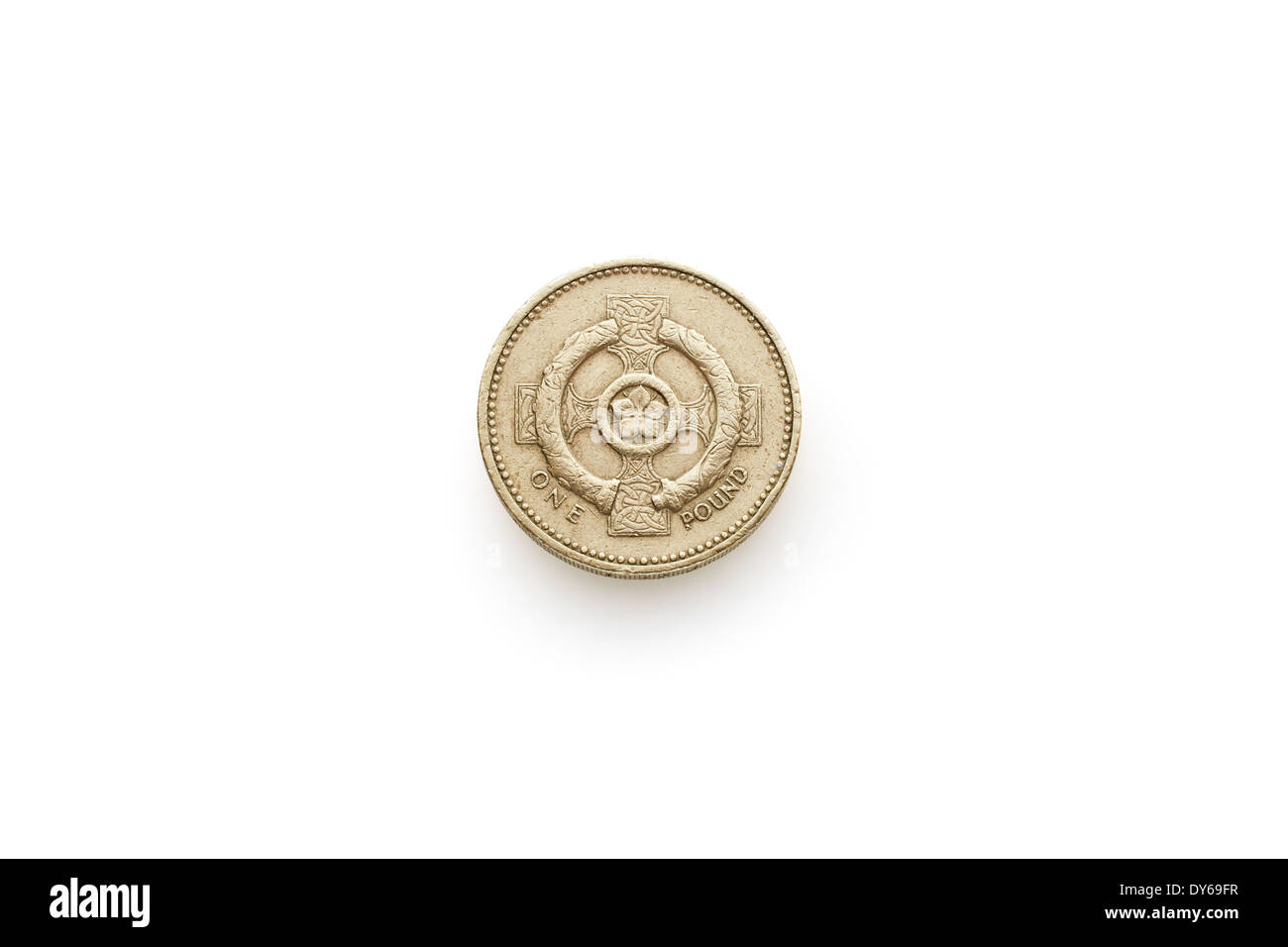 macro photograph of a pound coin with a shadow on a white background ...