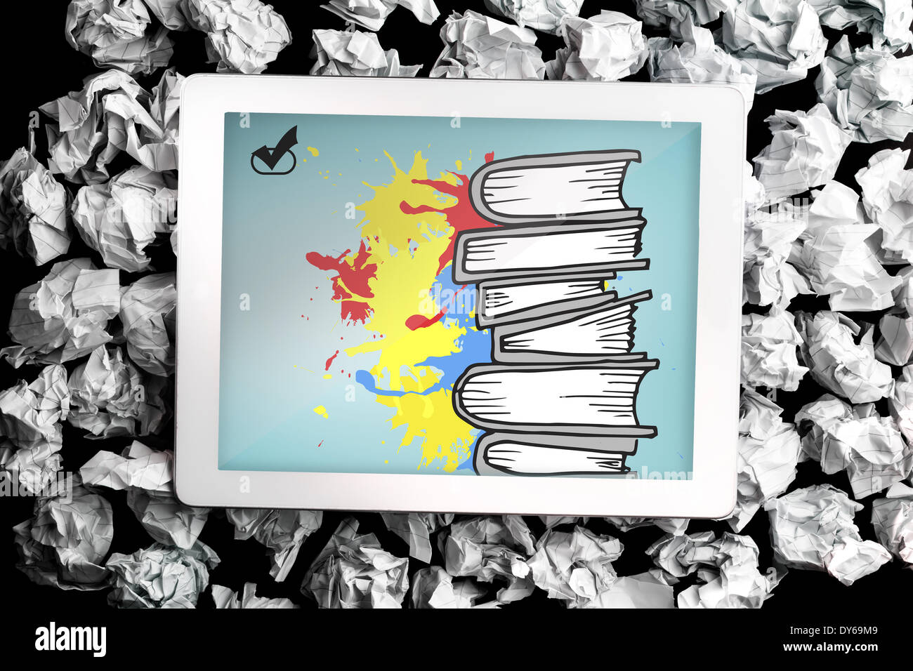 Pile of books on paint splashes on open book against white background ...