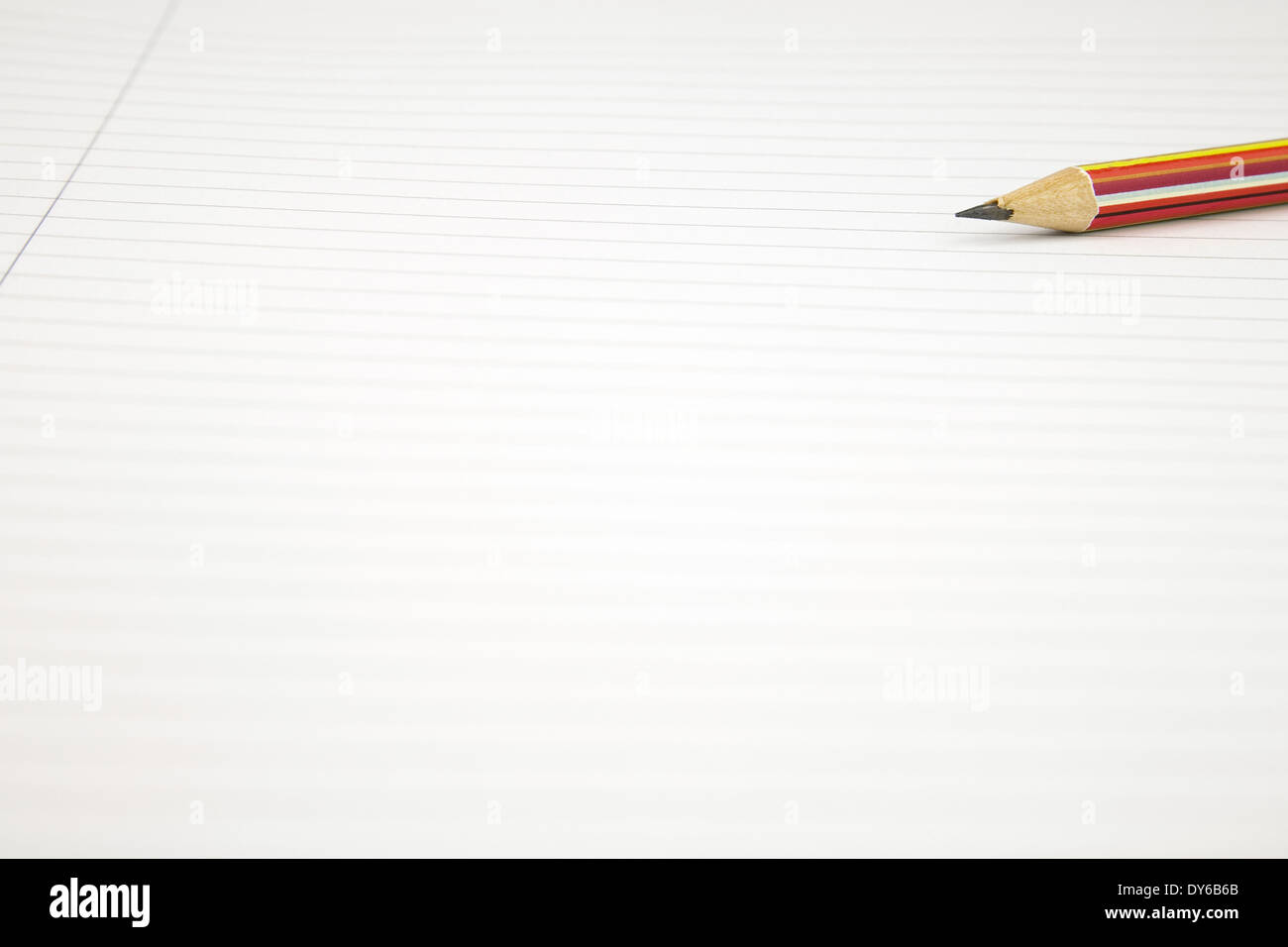 Close up of a Blank white lined Notepad with a pencil coming into shot ...