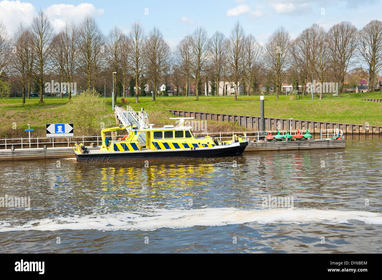 Yellow boat docked at a landing place in rural scenery Stock Photo - Alamy