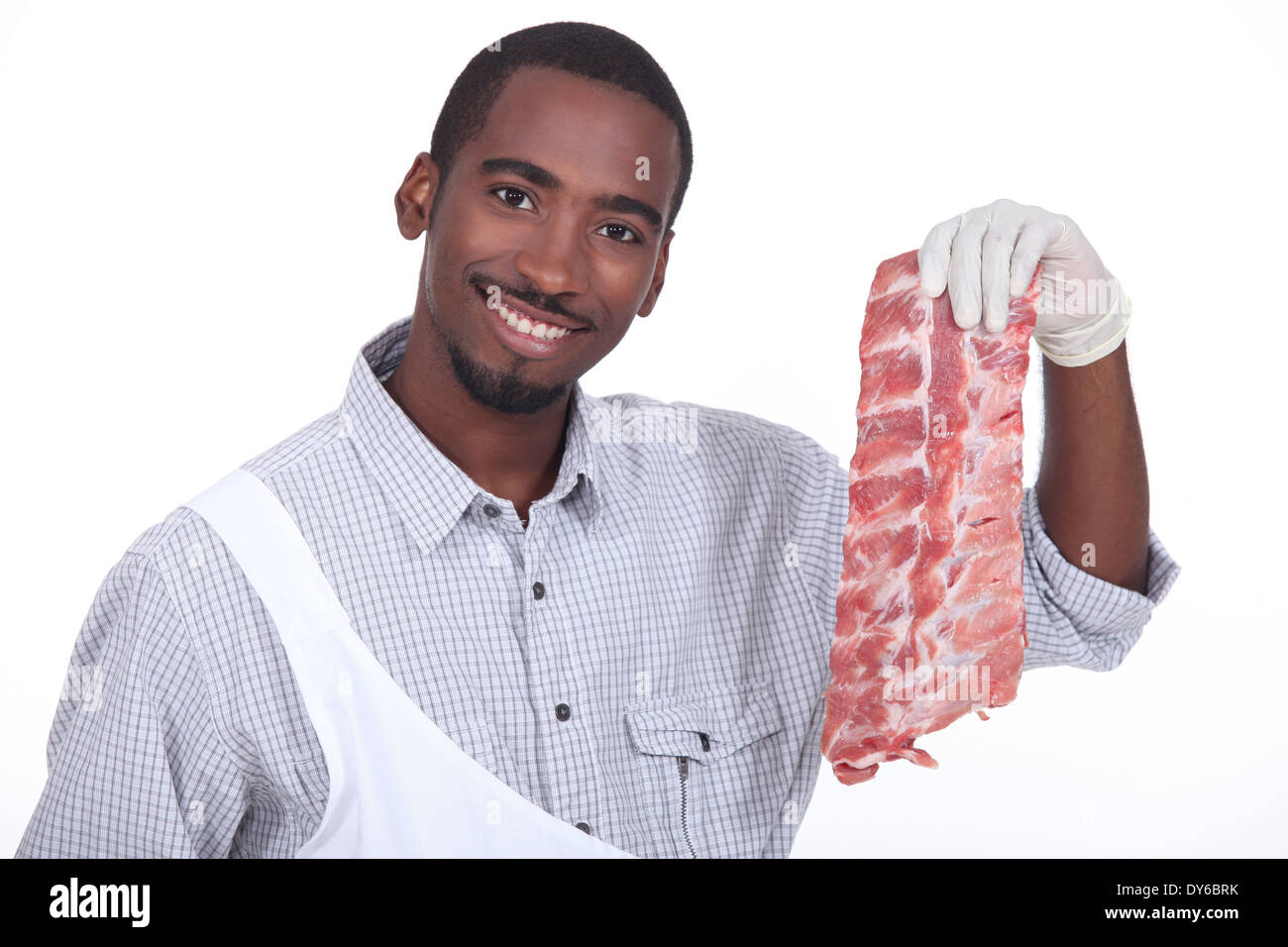 Butcher with a rack of ribs Stock Photo - Alamy
