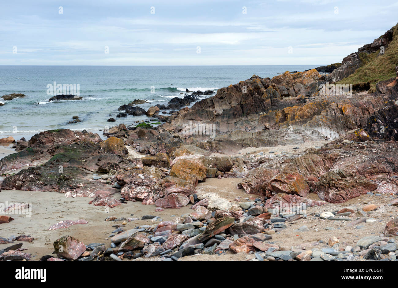 The rocky coastline from the beach at Sandend on the Banffshire coast ...