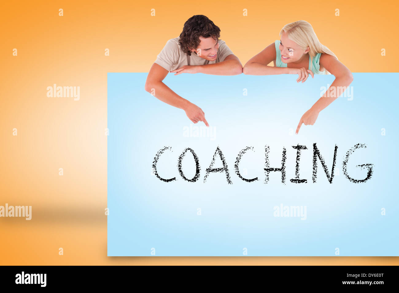 Attractive couple showing card with coaching Stock Photo - Alamy