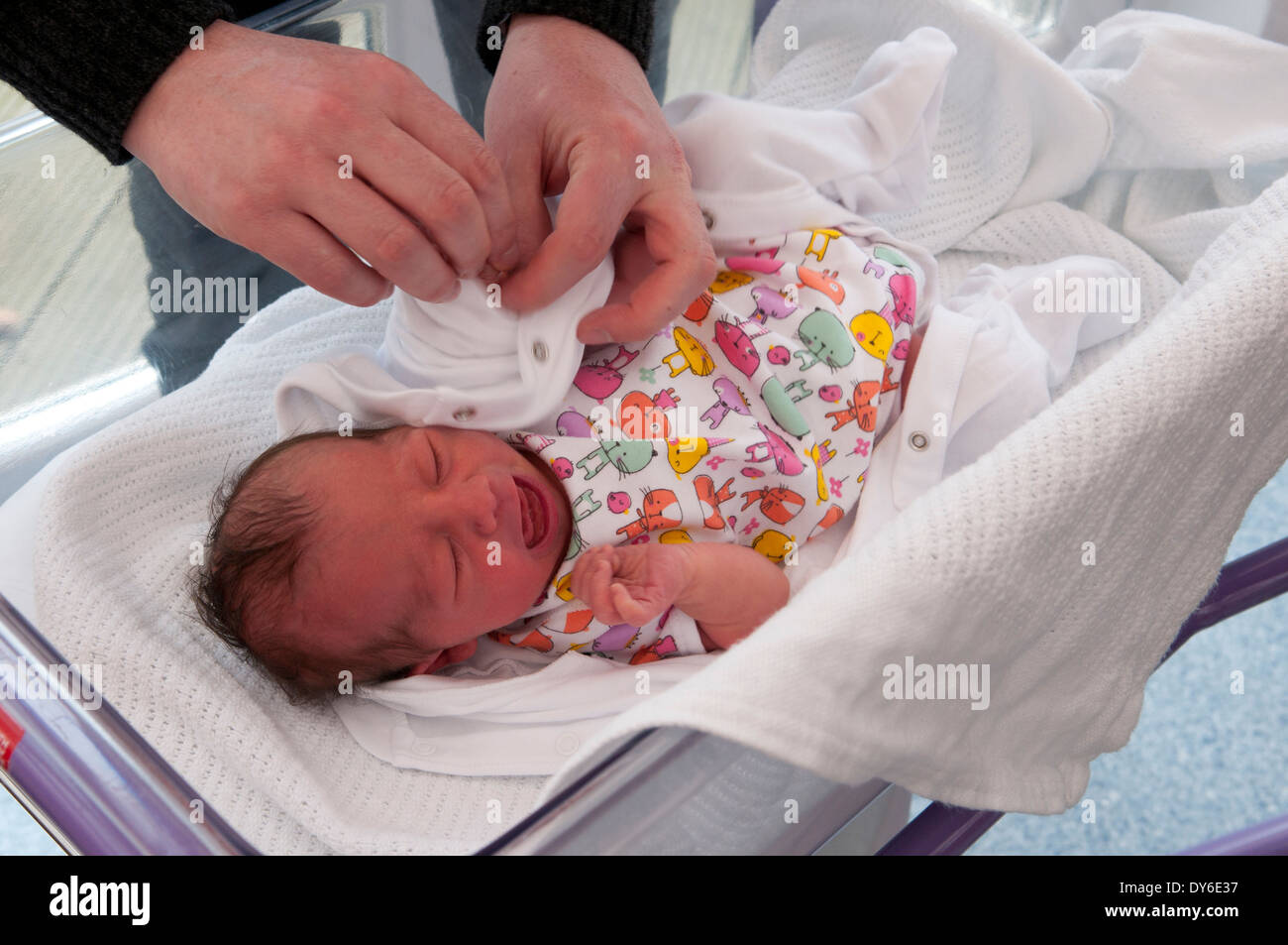 Newborn baby girl being dressed for the first time by her father Stock ...