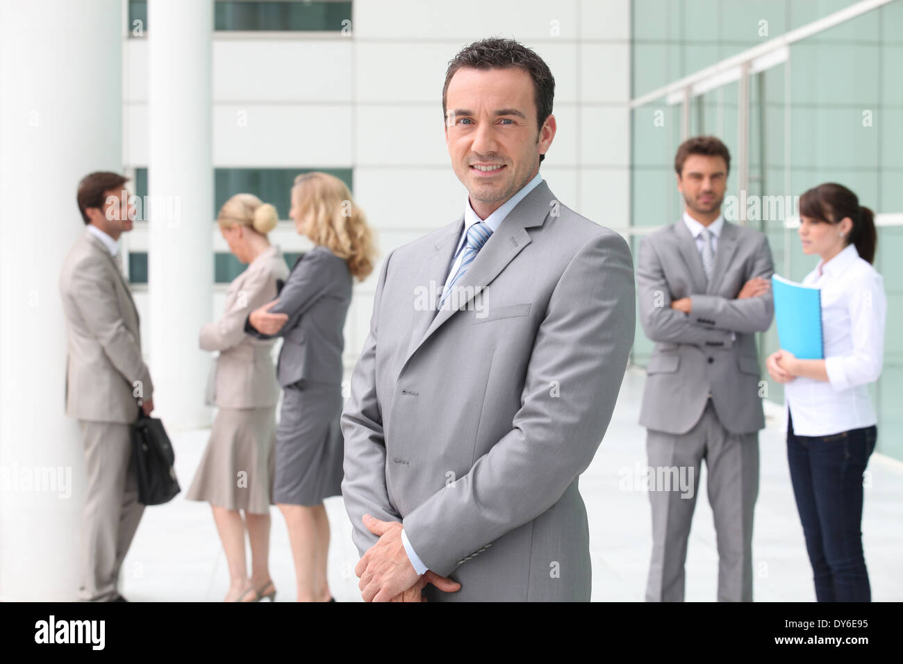 Group of business people stood outside building Stock Photo - Alamy