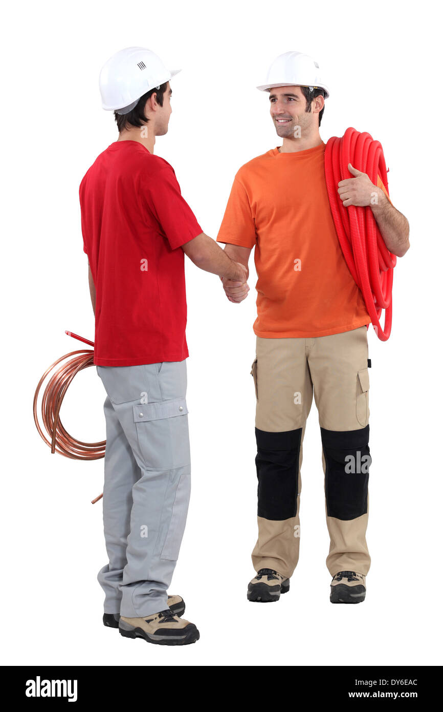 Plumbers shaking hands Stock Photo - Alamy