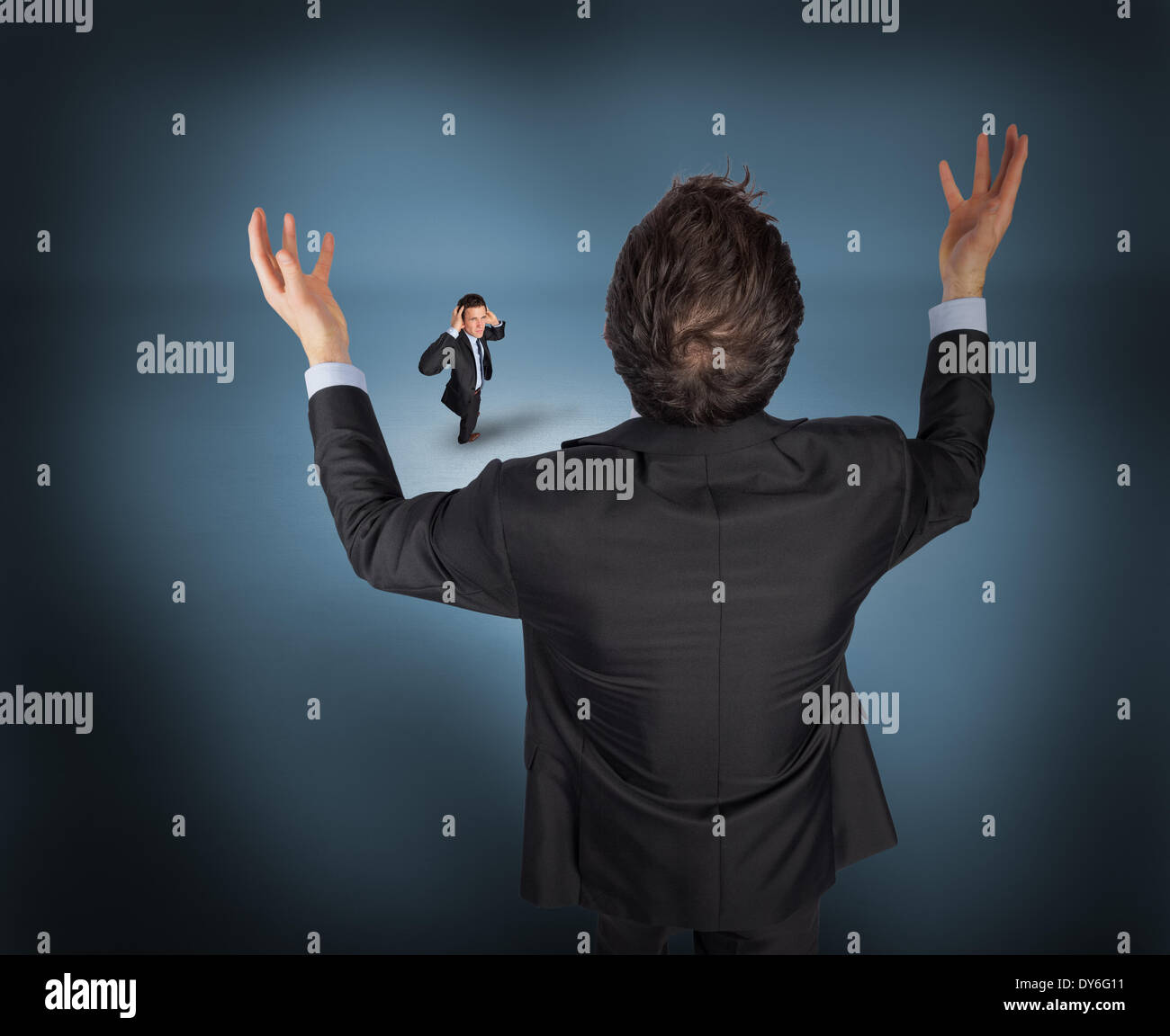 Composite image of gesturing businessman with tiny businessman Stock ...