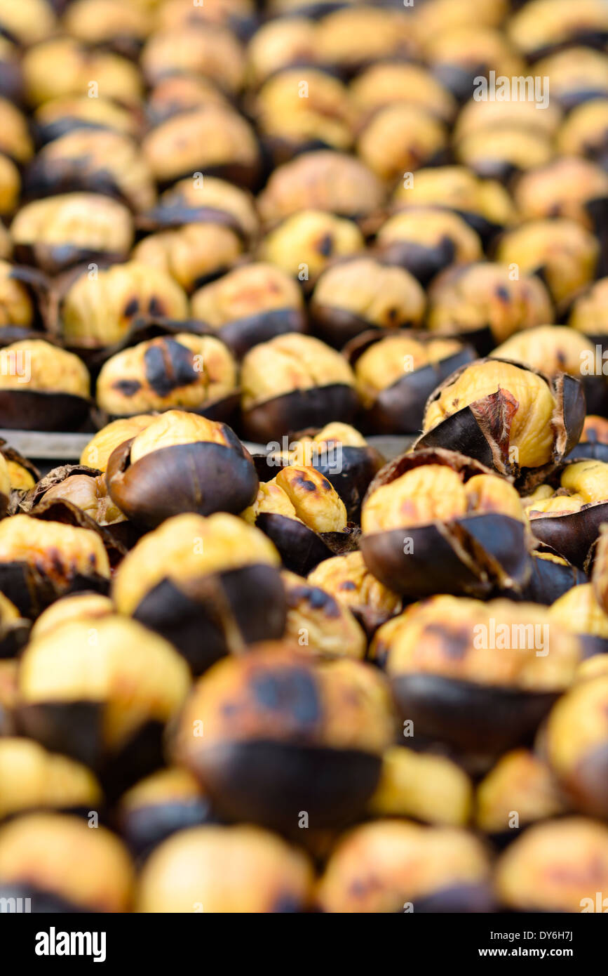 Backgrounds and textures: roasted chestnuts on a street vendor`s ...