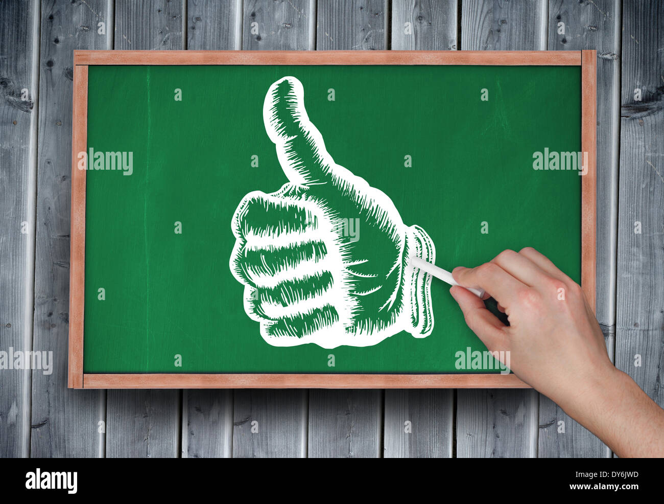 Composite image of hand drawing thumbs up with chalk Stock Photo - Alamy