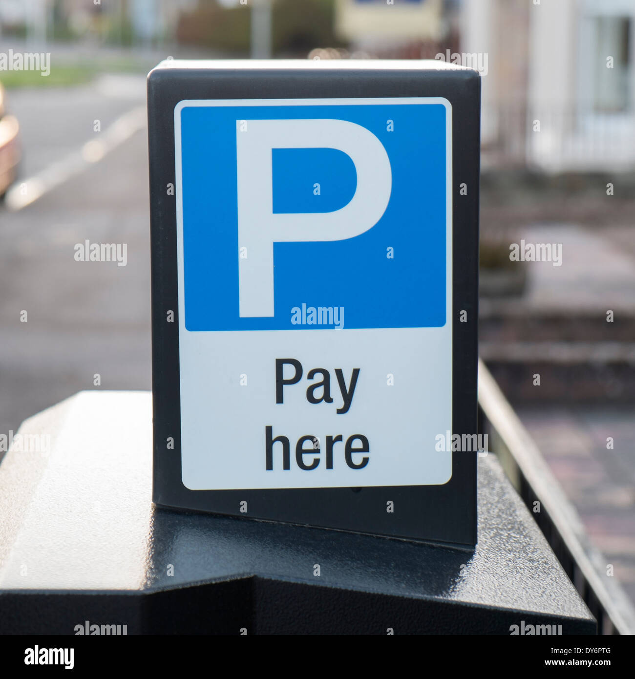 Pay here sign on top of a pay and display machine Stock Photo - Alamy