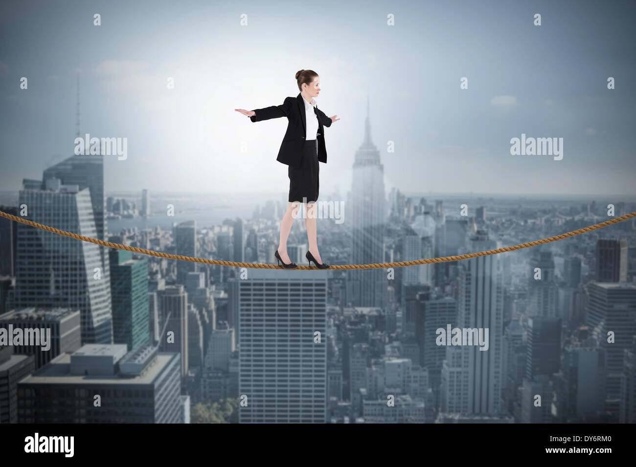Composite image of businesswoman performing a balancing act Stock Photo ...