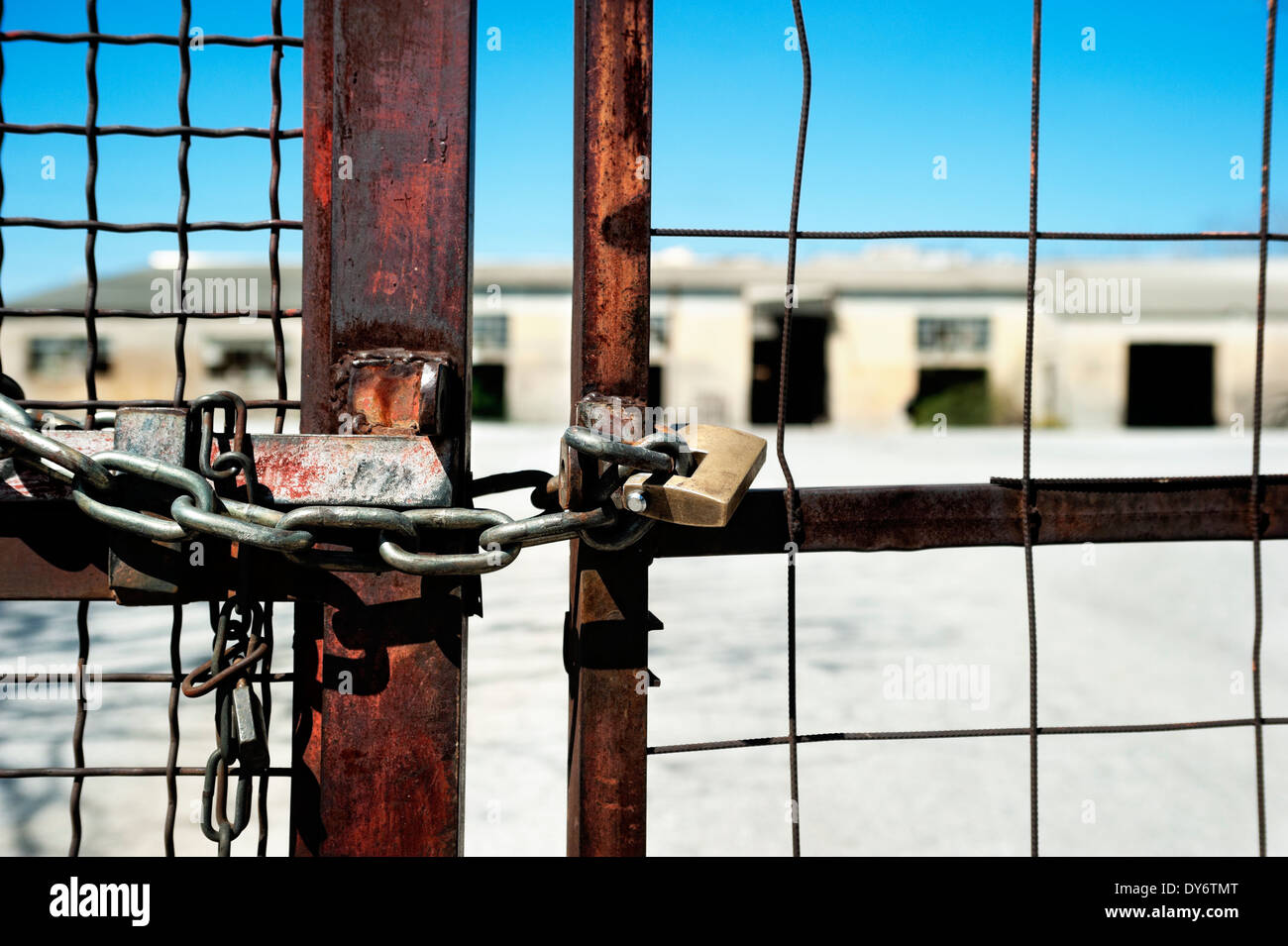 Locked gate of an abandoned building Stock Photo - Alamy