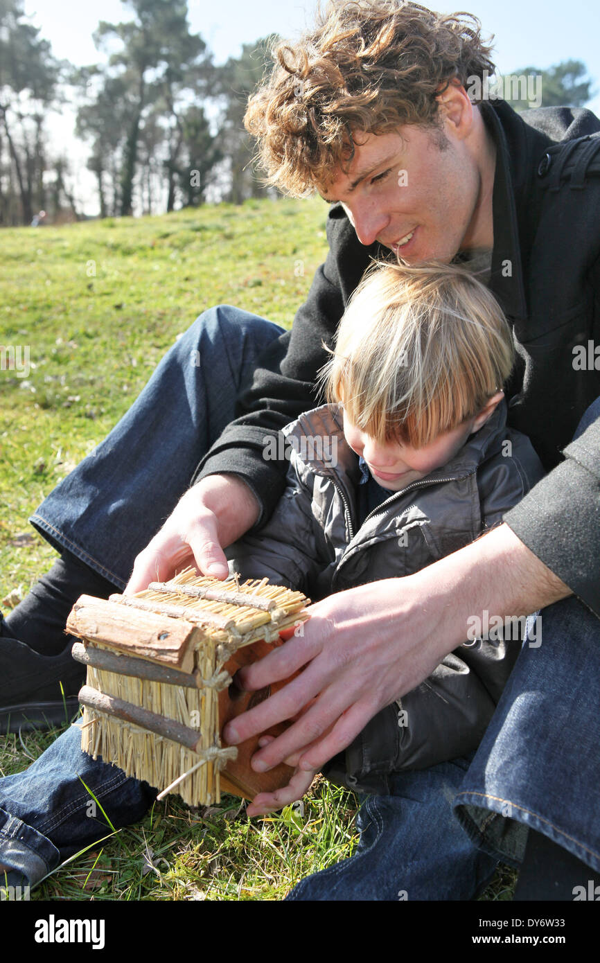 Family and son building an object Stock Photo - Alamy