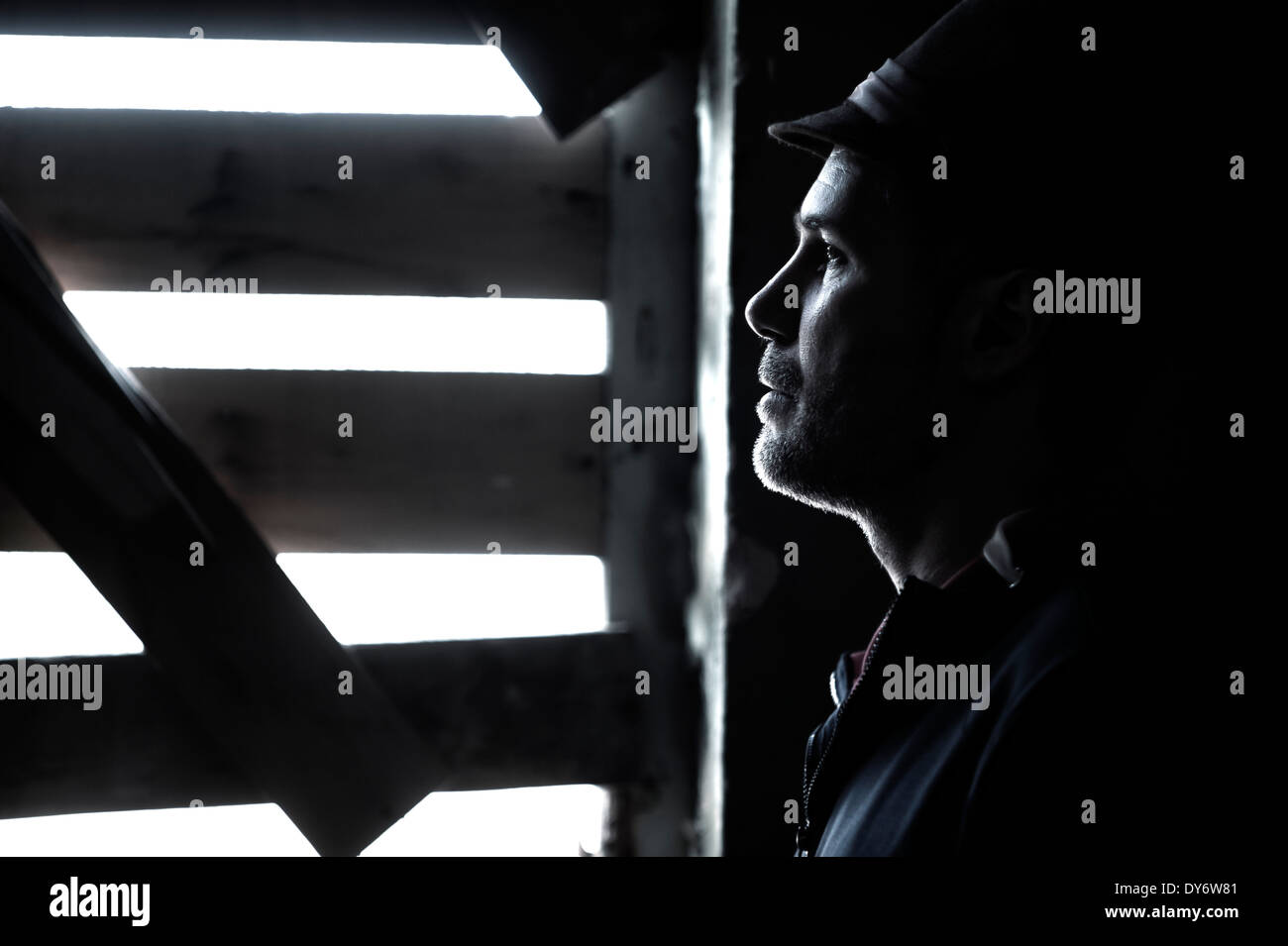 Man behind broken window Stock Photo - Alamy