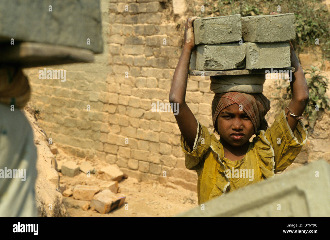 India Westbengal , children work in brick industry, girl carry bricks ...
