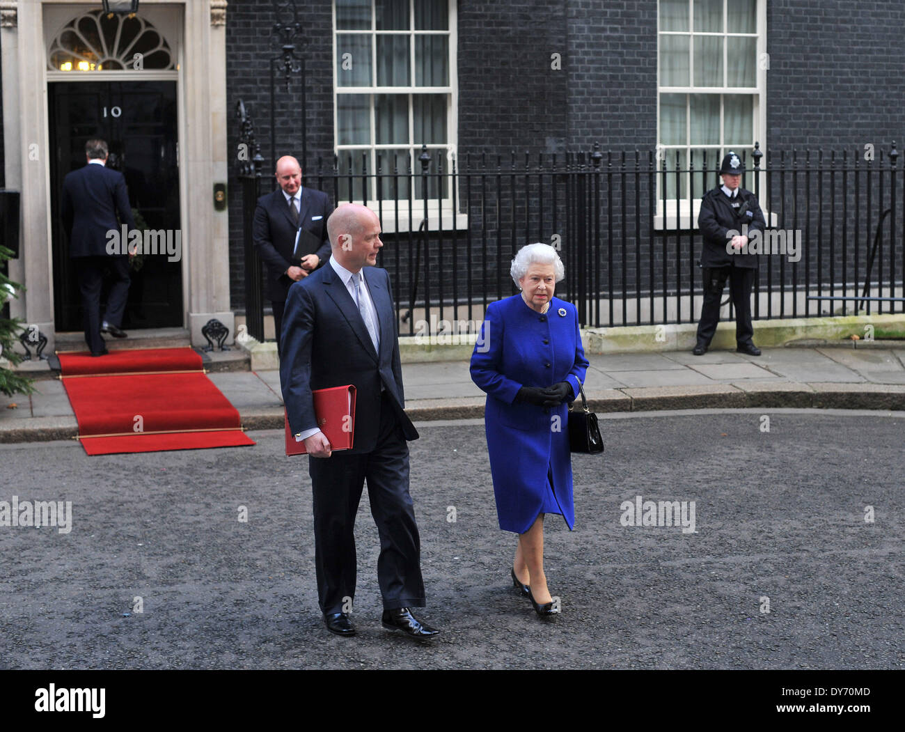 Queen Elizabeth II is escorted by Foreign Secretary William Hague on ...