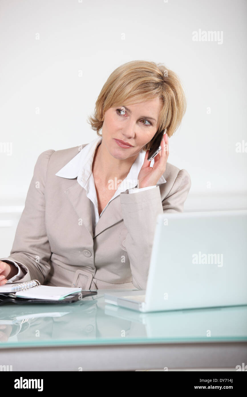 Executive secretary at her desk Stock Photo - Alamy