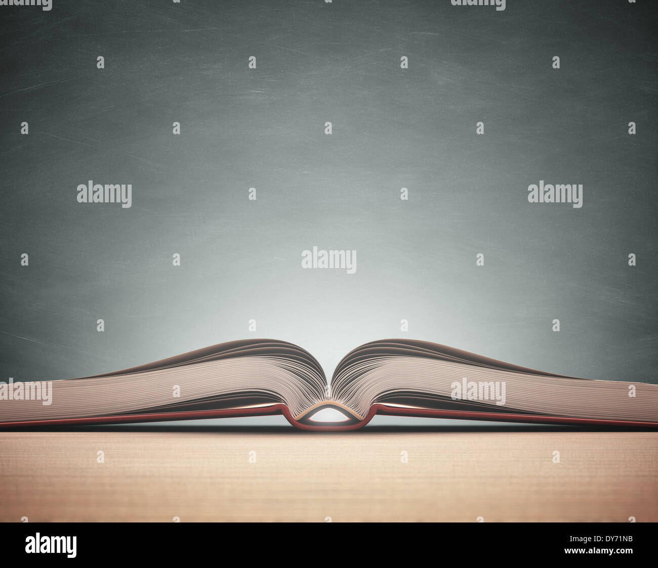 Open book over the table with blackboard on background. Clipping path ...