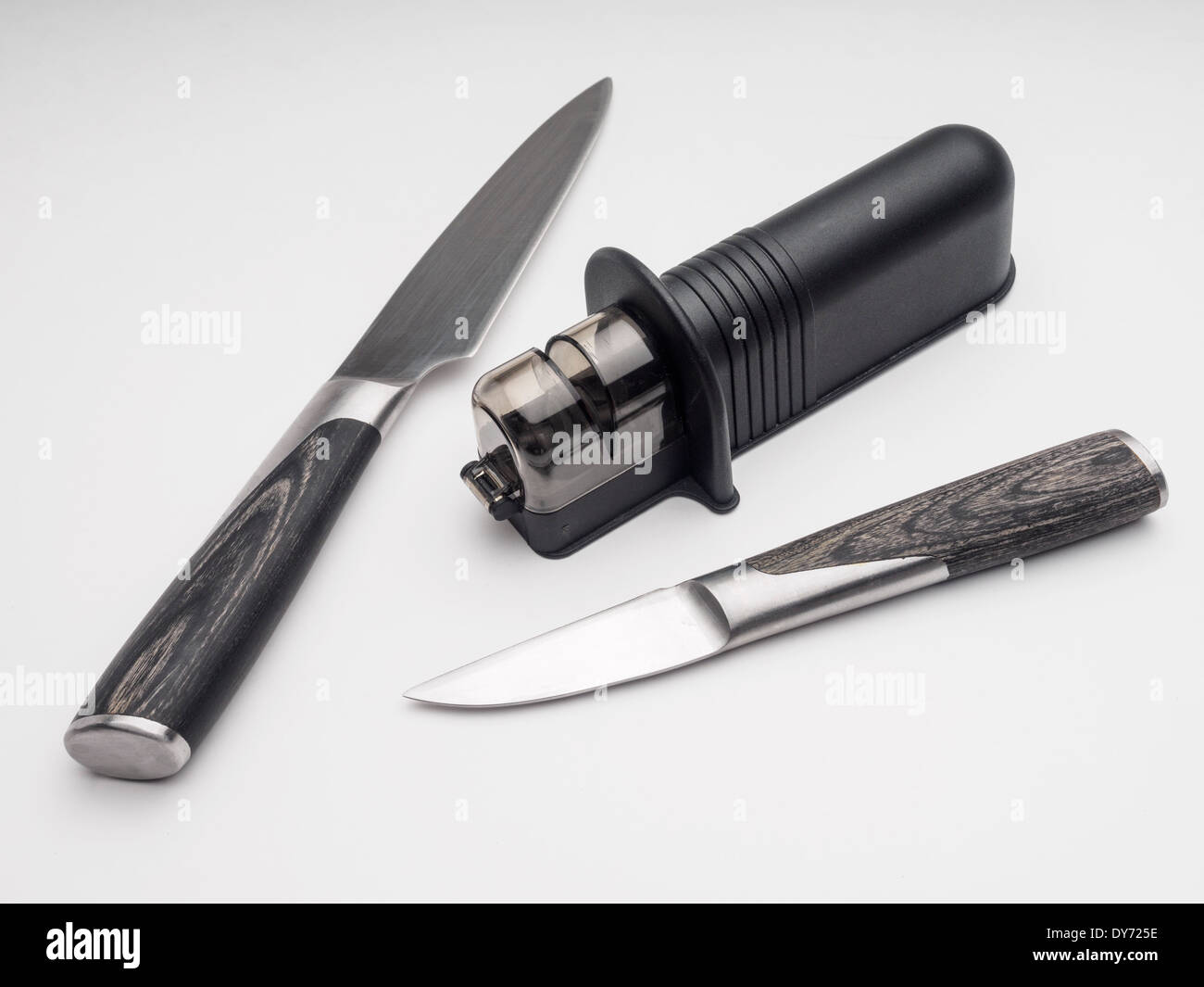 Kitchen knifes and knife sharpener cut out isolated on white background ...