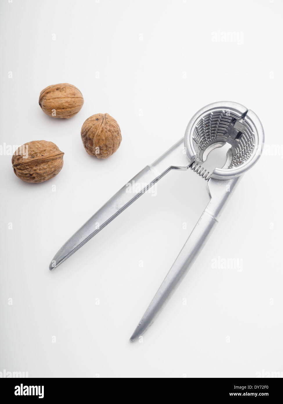 Walnuts and nutcracker cut out isolated on white background Stock Photo ...