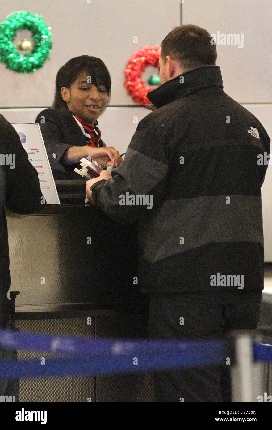 A bodyguard holding One Direction's band members passports checks them ...
