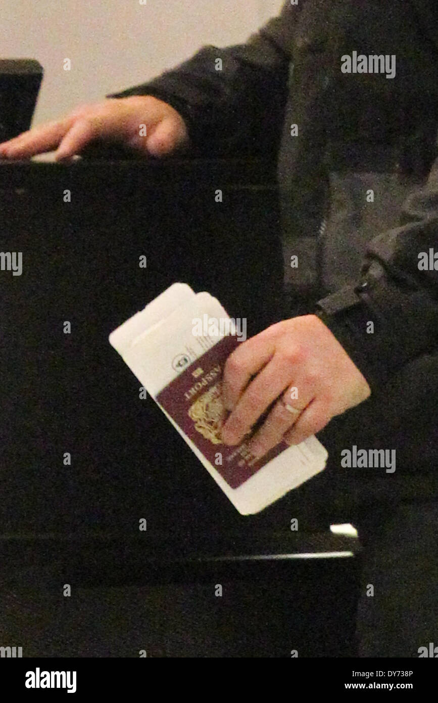 A bodyguard holding One Direction's band members passports checks them ...