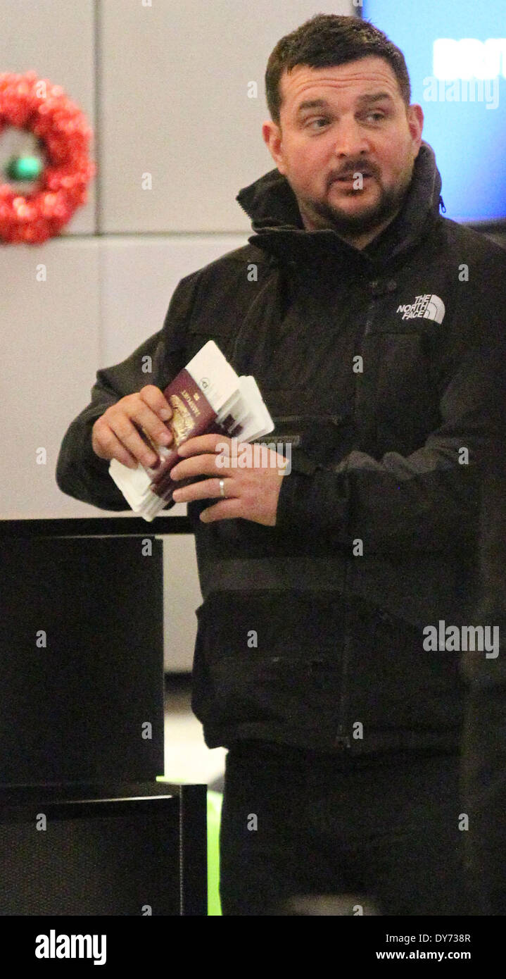 A bodyguard holding One Direction's band members passports checks them ...