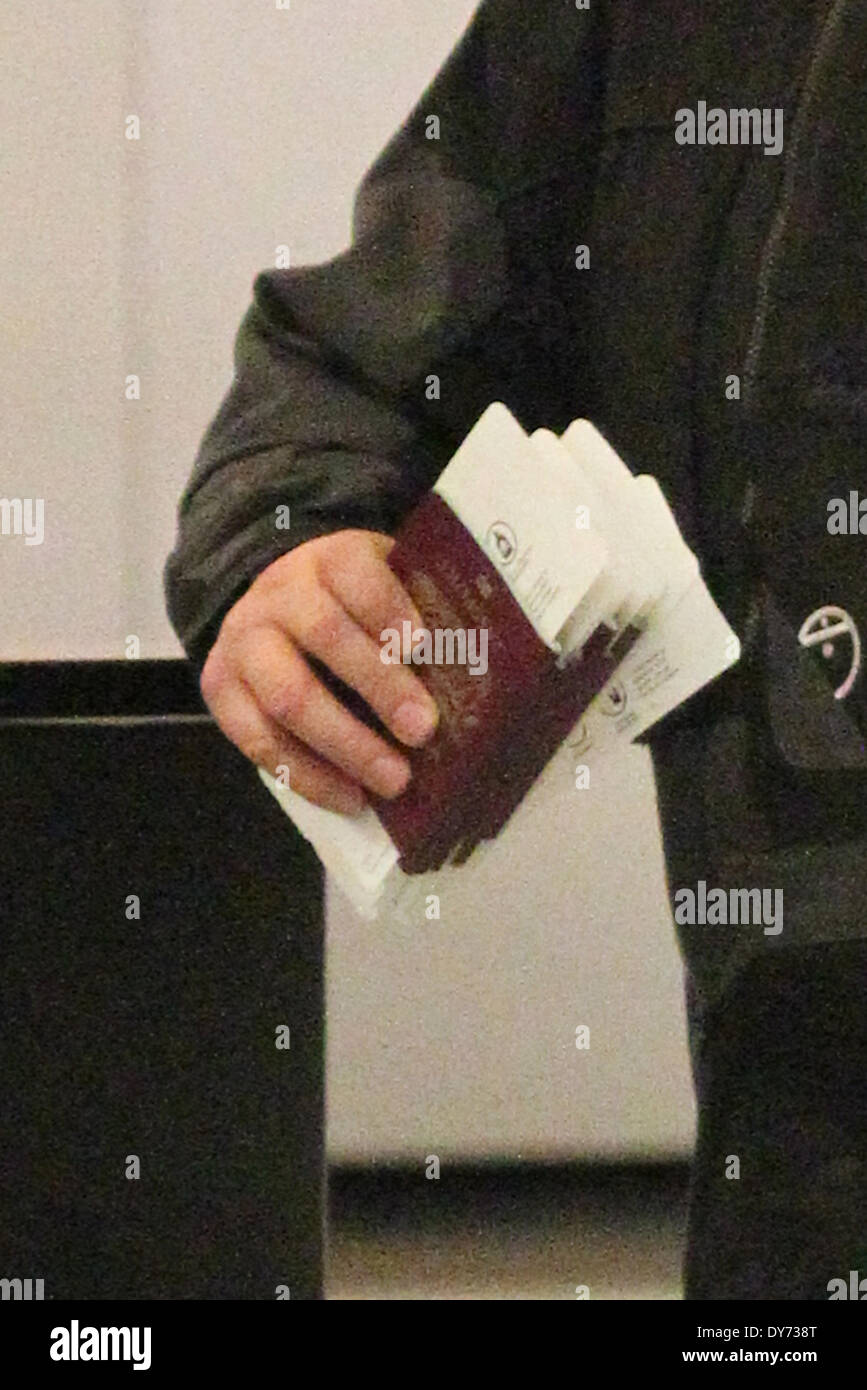 A bodyguard holding One Direction's band members passports checks them ...
