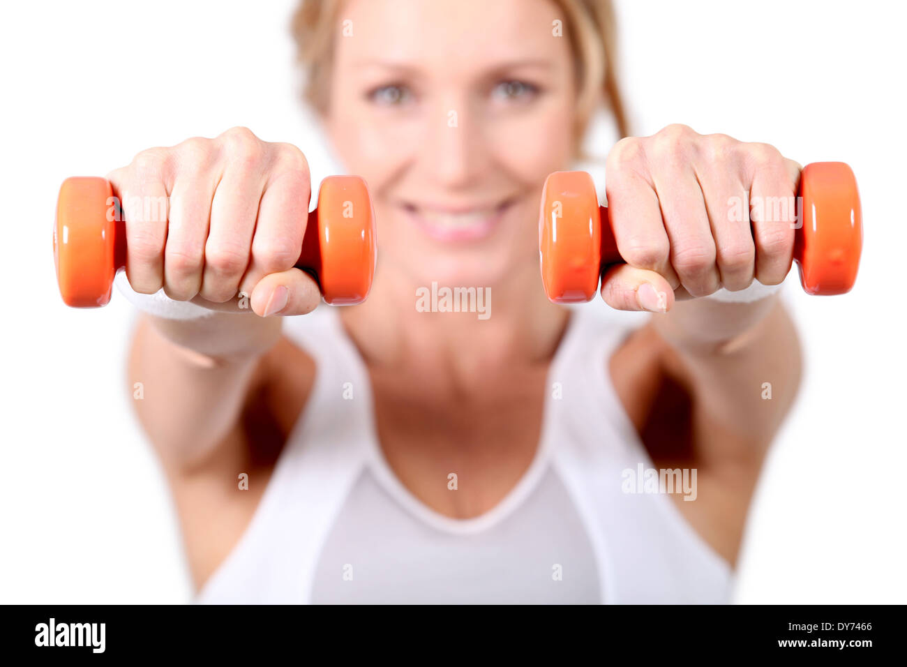 Woman using hand weights during fitness session Stock Photo - Alamy