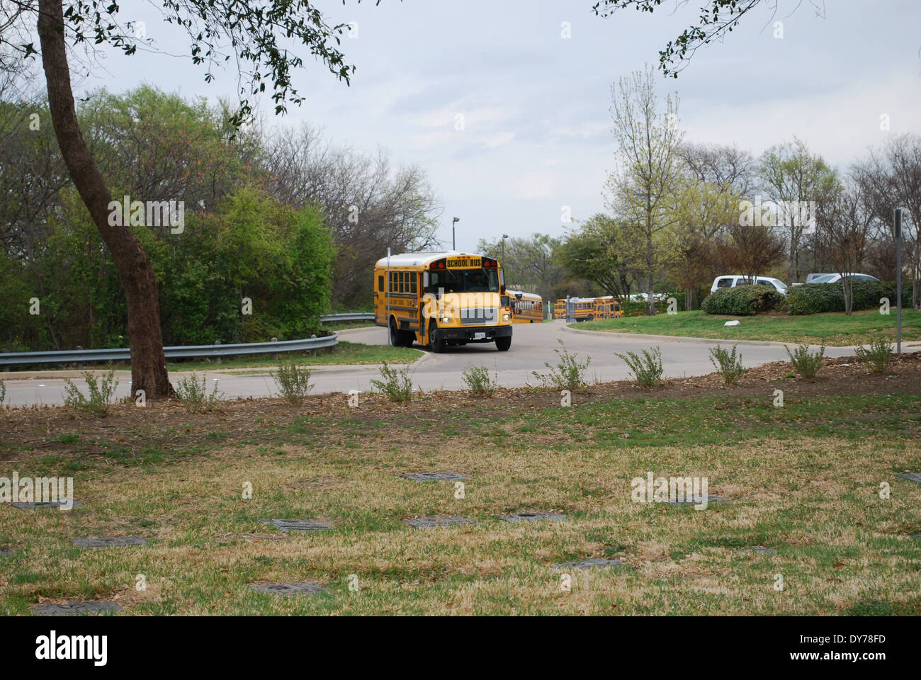 Yellow school buses leave a bus barn for the after noon trip from ...